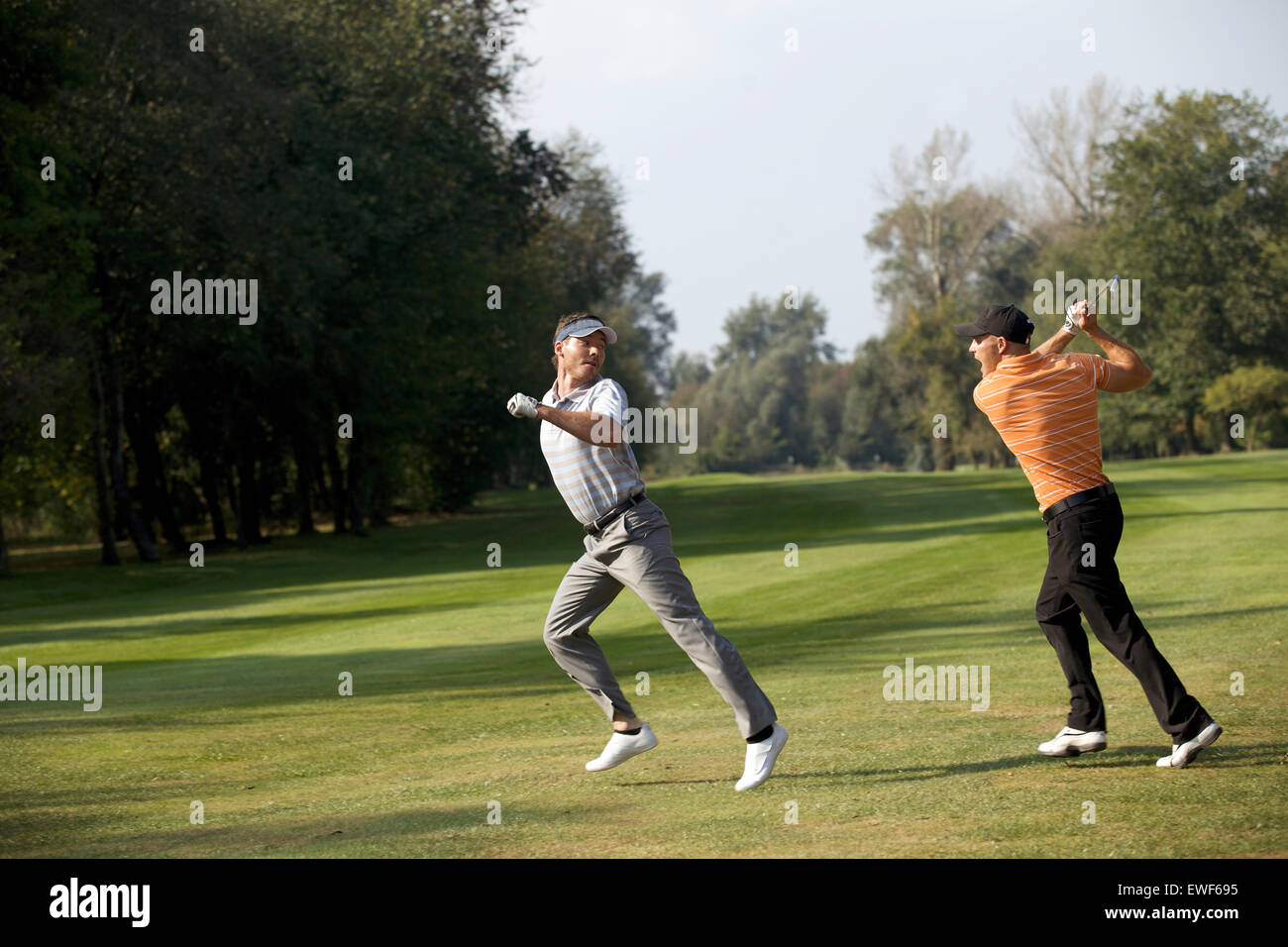 Friends having fun in golf course Stock Photo - Alamy