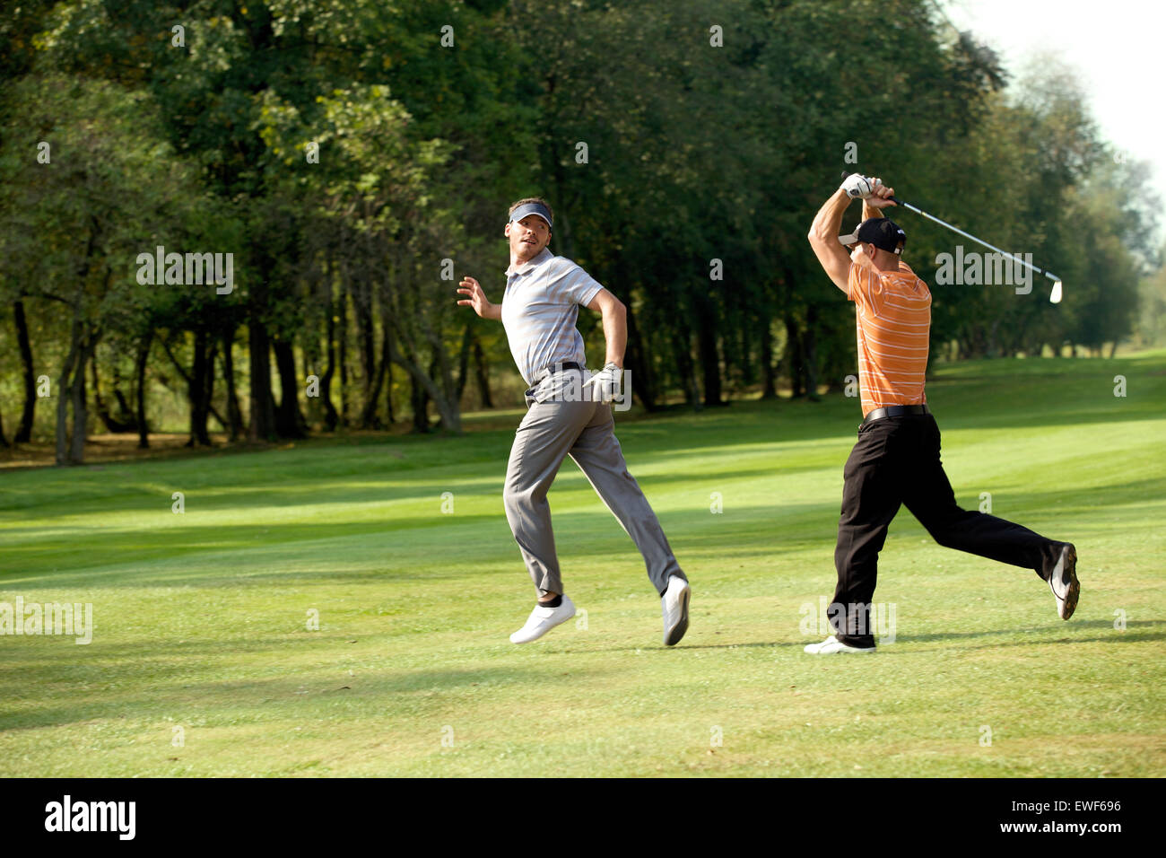 Friends having fun in golf course Stock Photo - Alamy