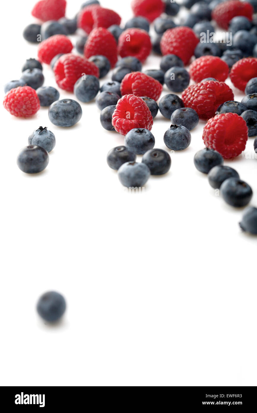 Raspberries and blueberries on white background Stock Photo - Alamy
