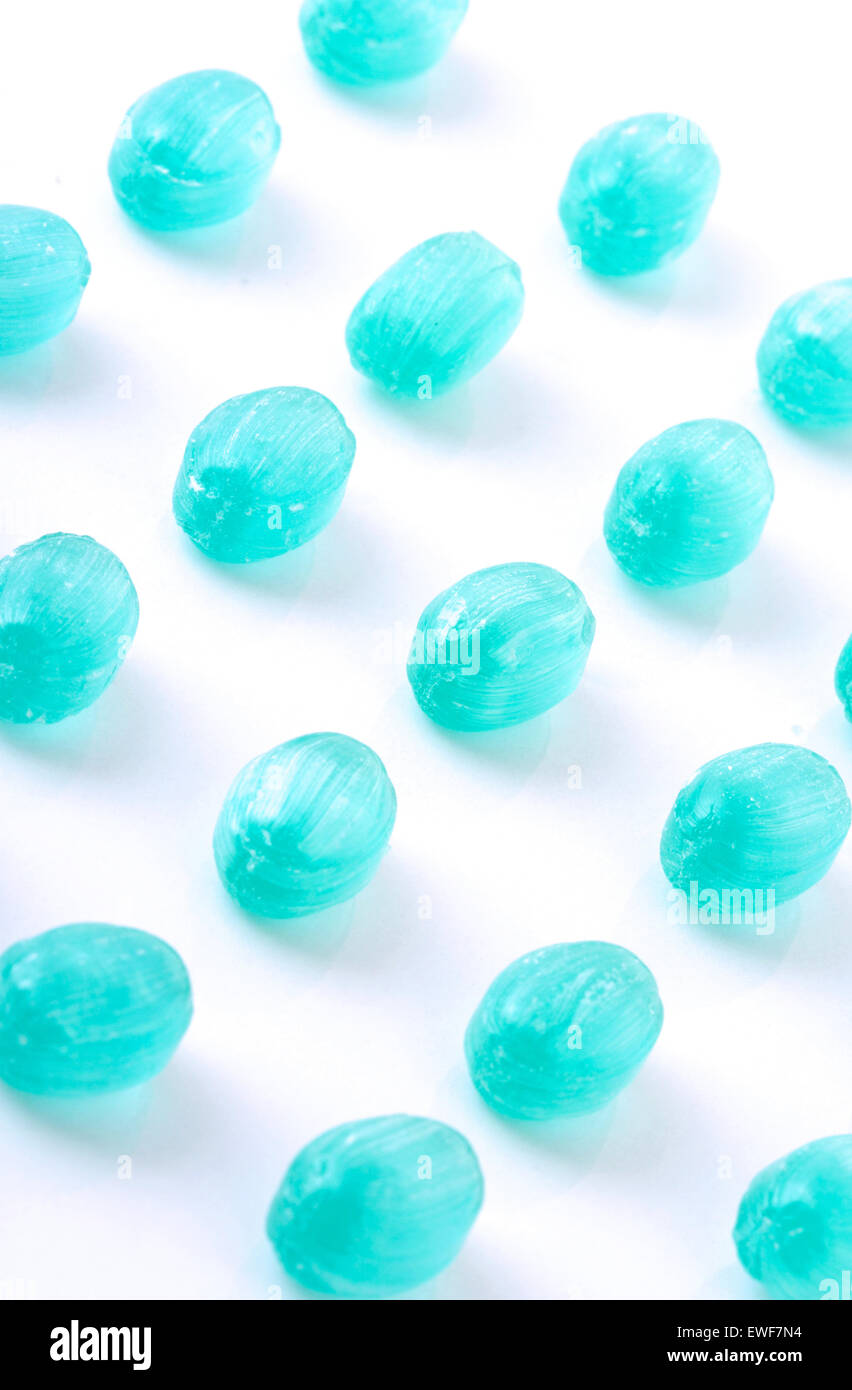 Blue candies on white background Stock Photo - Alamy
