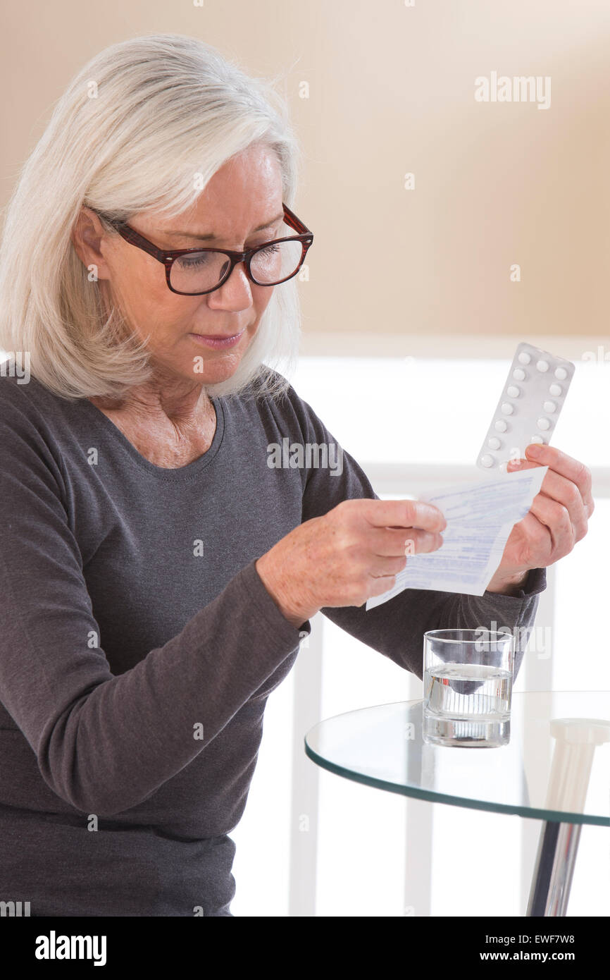 Senior woman taking medicines hi-res stock photography and images - Alamy