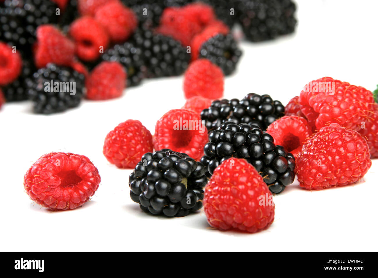 Raspberries and blackberries on white background Stock Photo - Alamy