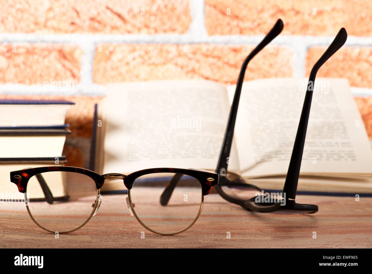 reading glasses and books on the table Stock Photo - Alamy