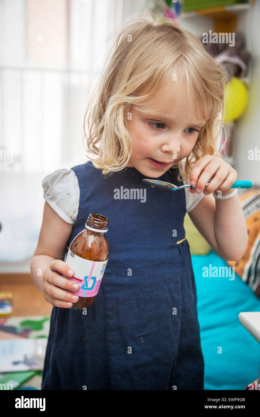 Taking medicine, child, spoon hi-res stock photography and images - Alamy