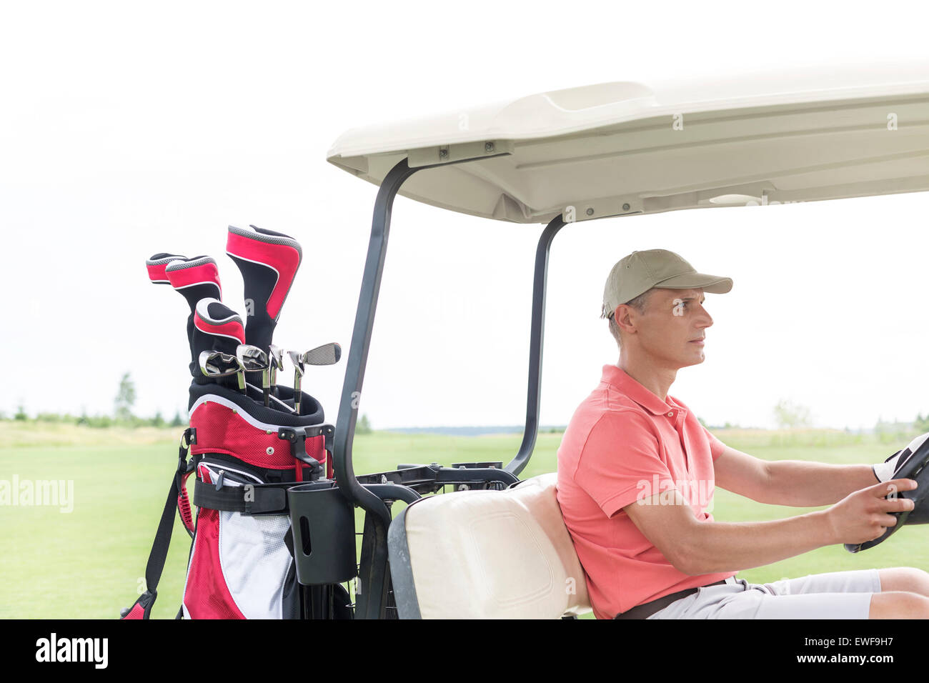 Male golfer driving golf cart hi-res stock photography and images - Alamy