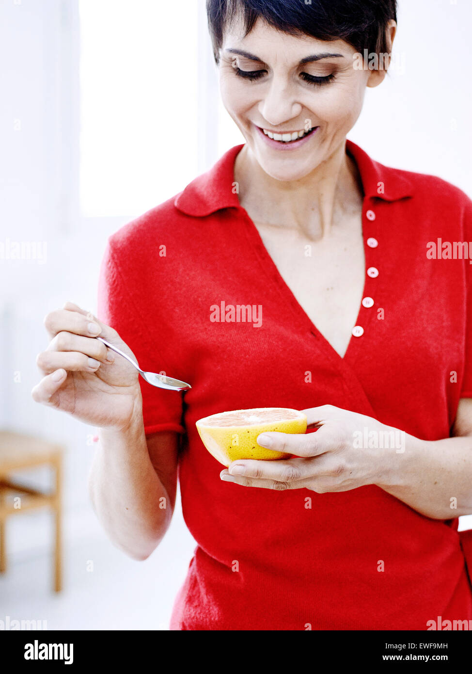 WOMAN EATING FRUIT Stock Photo - Alamy