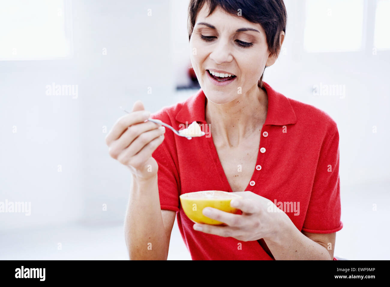 WOMAN EATING FRUIT Stock Photo - Alamy