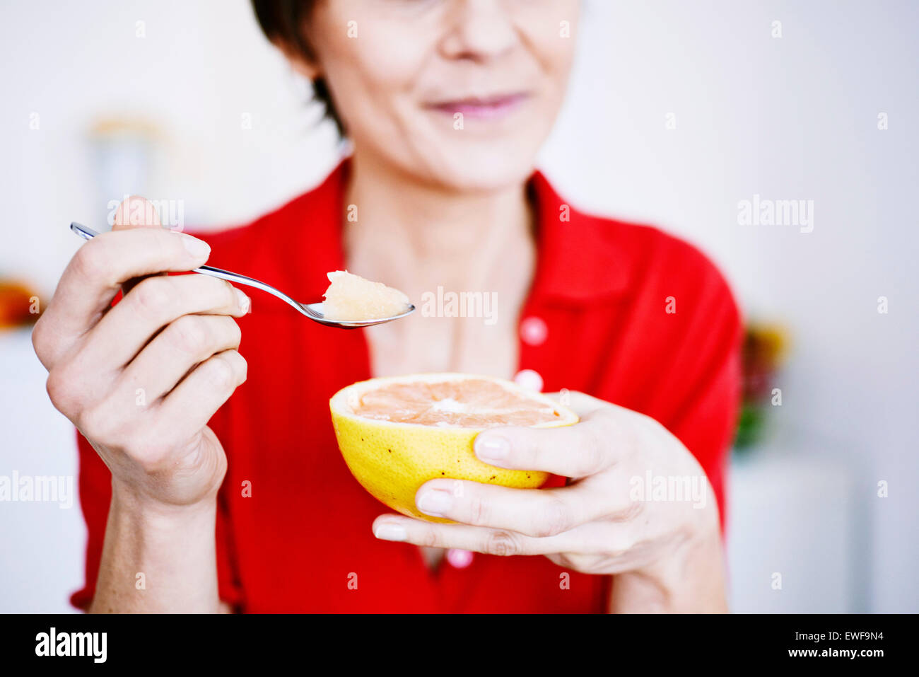 WOMAN EATING FRUIT Stock Photo - Alamy
