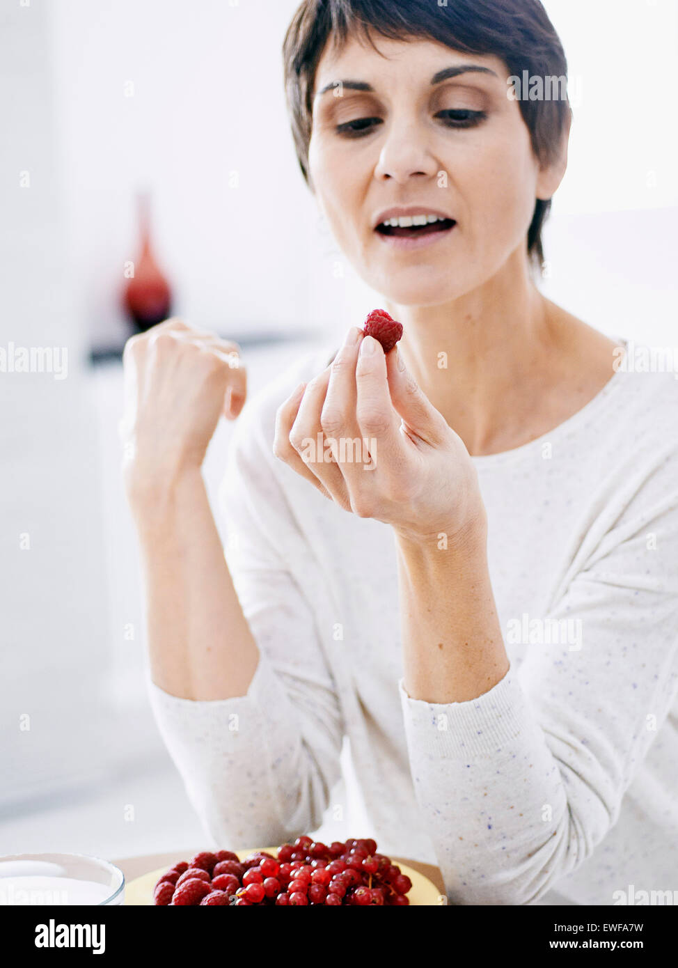 WOMAN EATING FRUIT Stock Photo - Alamy