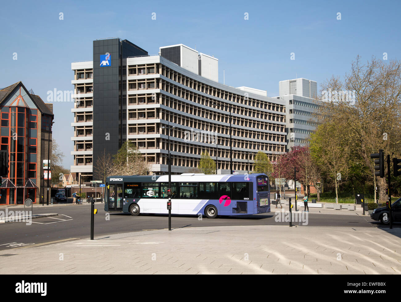 Single decker bus passing AXA insurance offices in central Ipswich ...