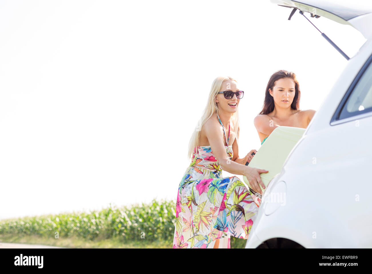 Female friends loading luggage hi-res stock photography and images - Alamy