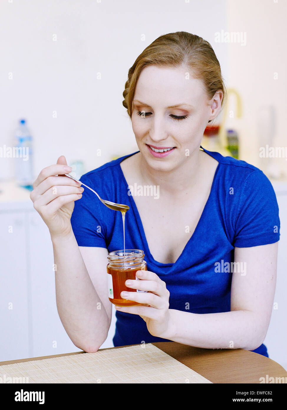 WOMAN EATING HONEY Stock Photo - Alamy