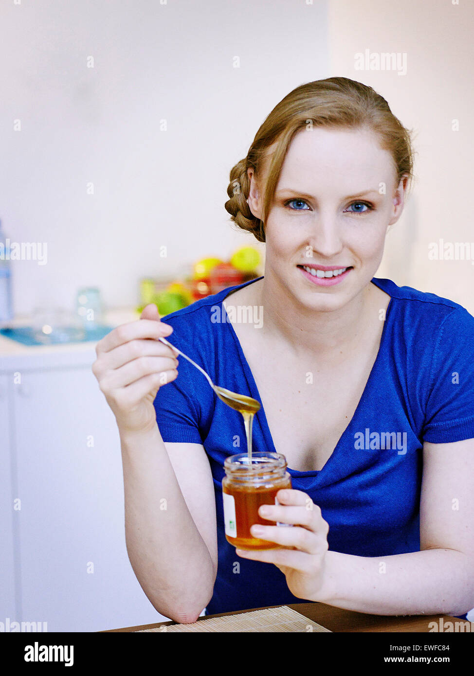 WOMAN EATING HONEY Stock Photo - Alamy