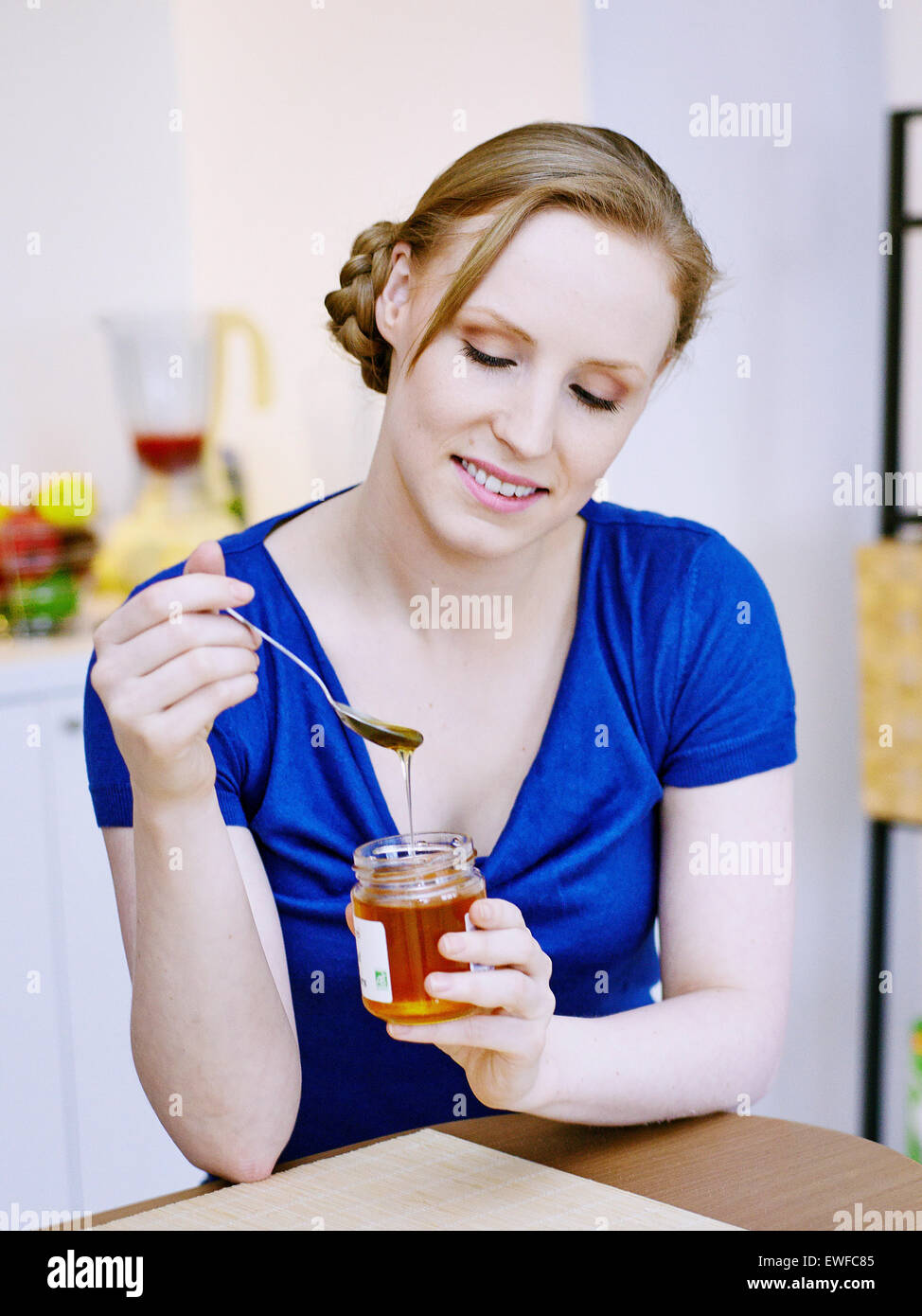 WOMAN EATING HONEY Stock Photo - Alamy