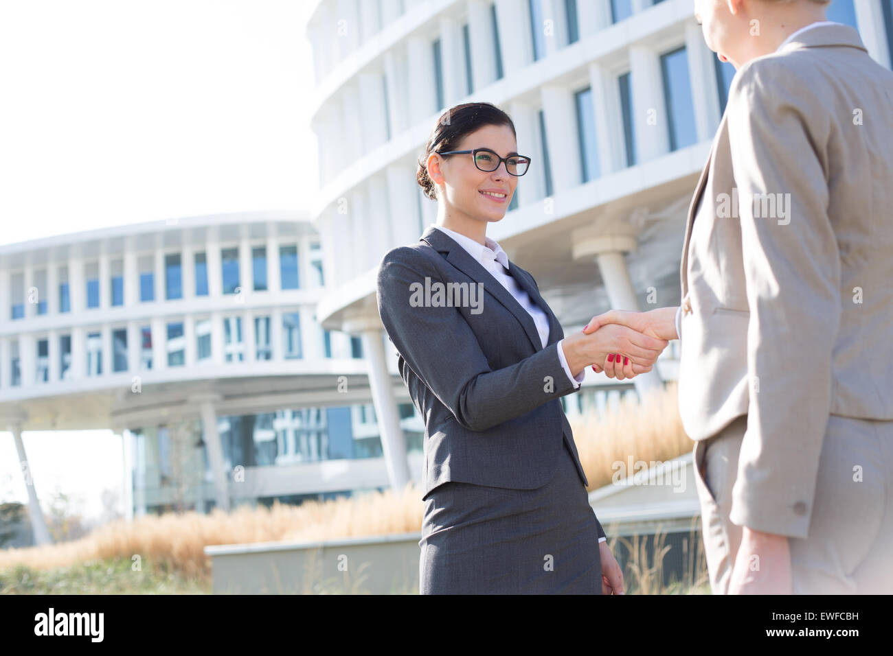 Women shaking hands outdoors hi-res stock photography and images - Alamy
