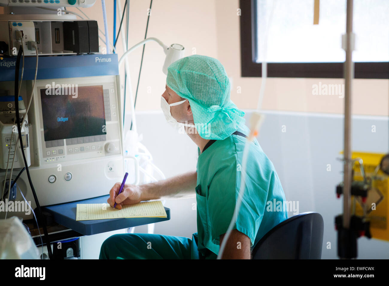 Doctor sits writing hi-res stock photography and images - Alamy