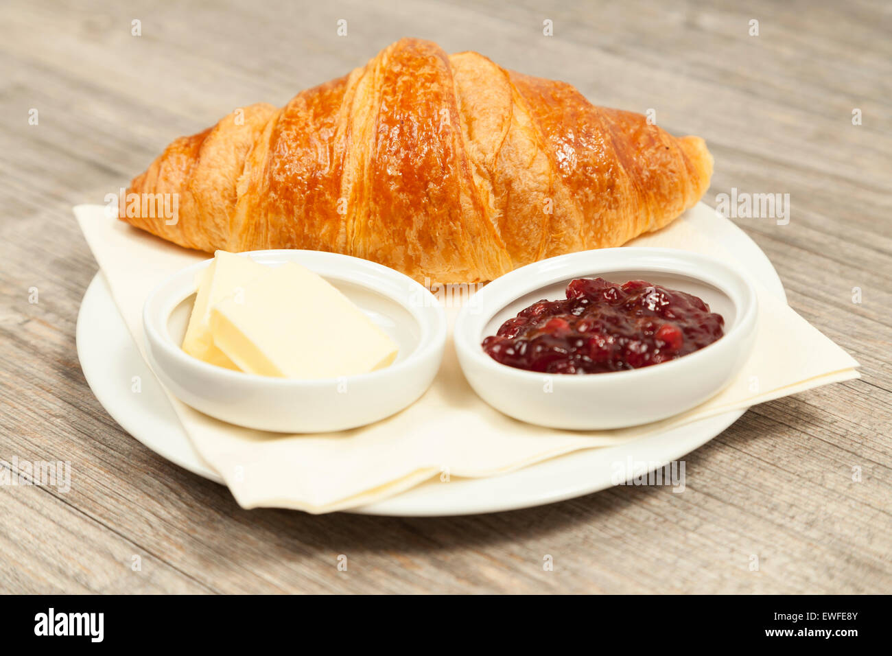 Croissant with jam and butter Stock Photo - Alamy