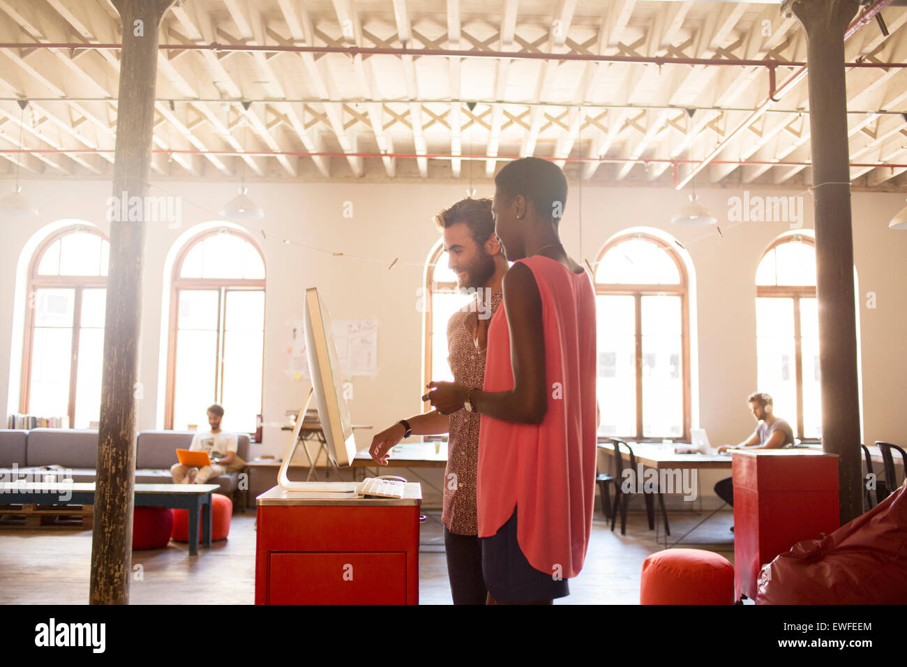 Creative business people working at computer in open office Stock Photo ...