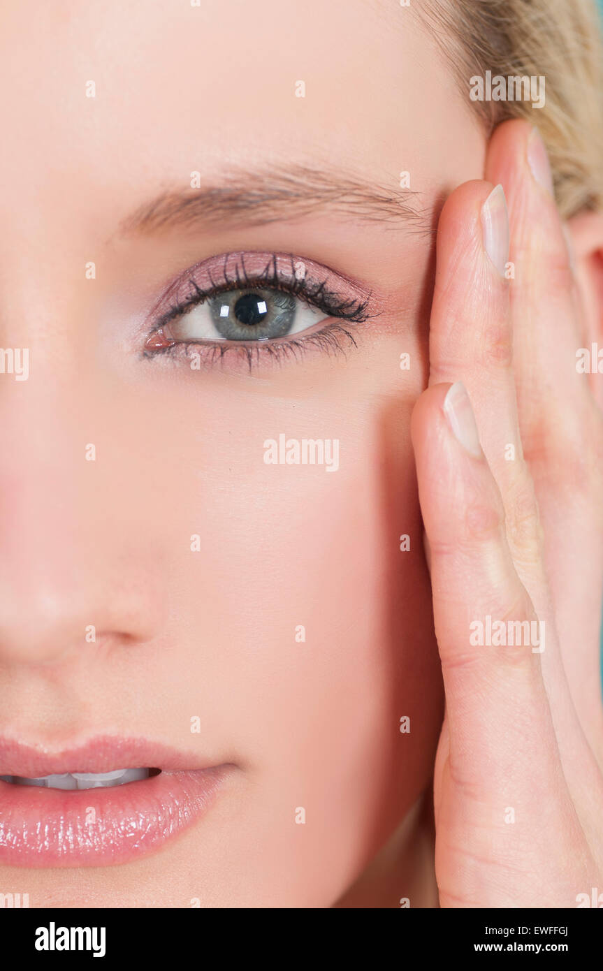 Beautiful young woman hand touching face Stock Photo - Alamy