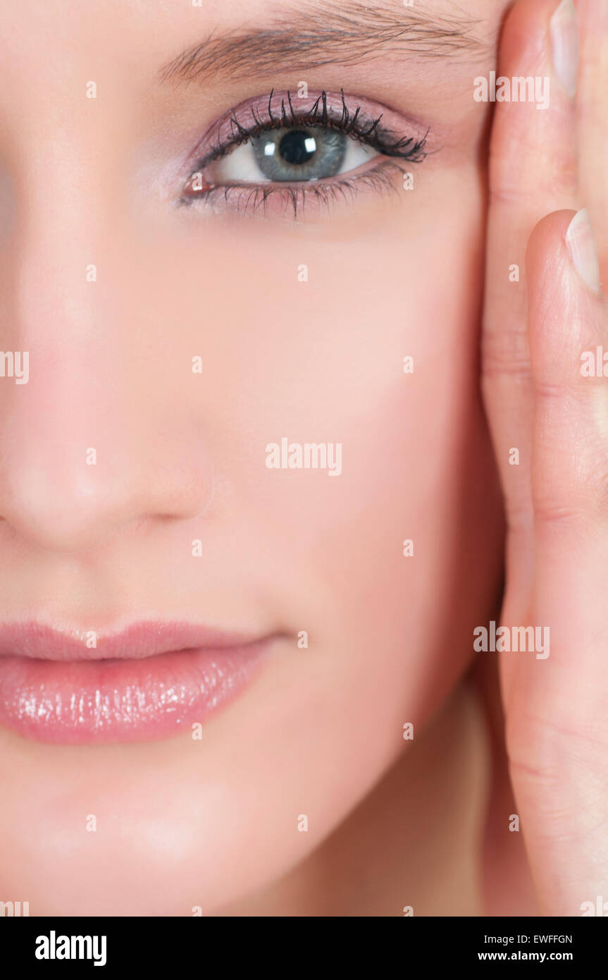 Beautiful young woman hand touching face Stock Photo - Alamy
