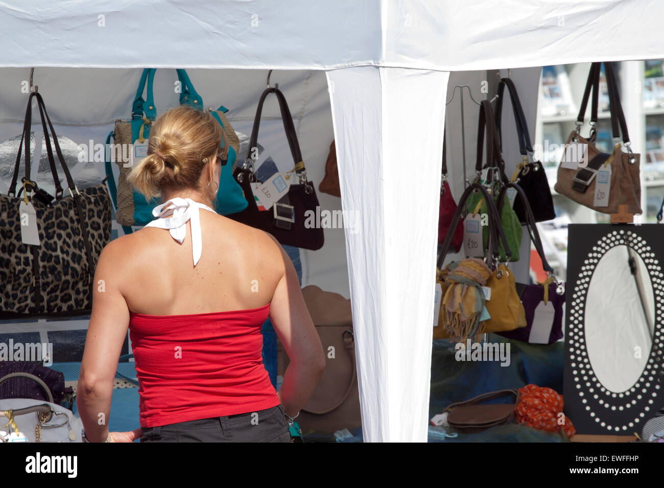 Sun tanned shoulders of a woman shopping on street market Stock Photo ...