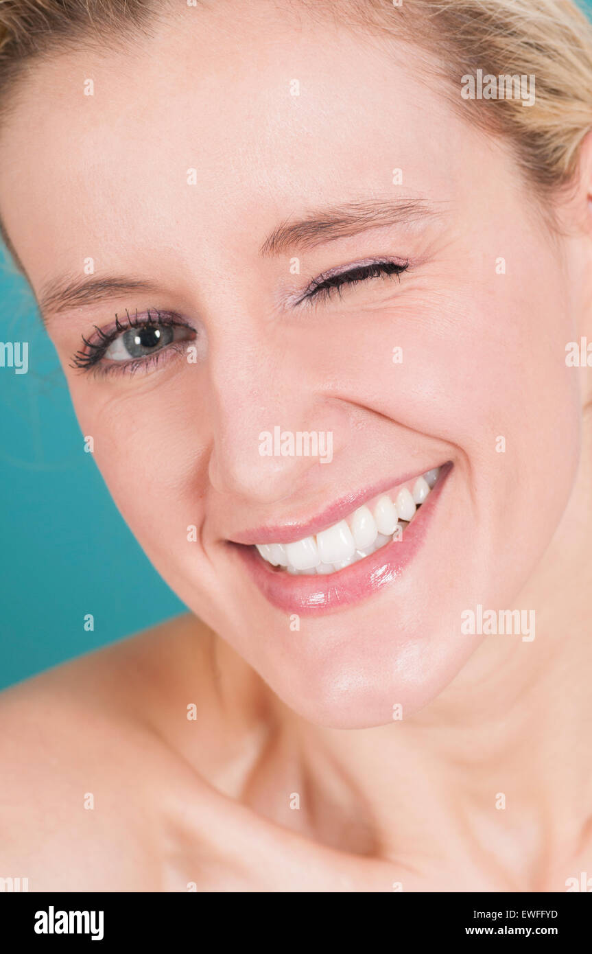 Beautiful young Caucasian woman winking Stock Photo - Alamy