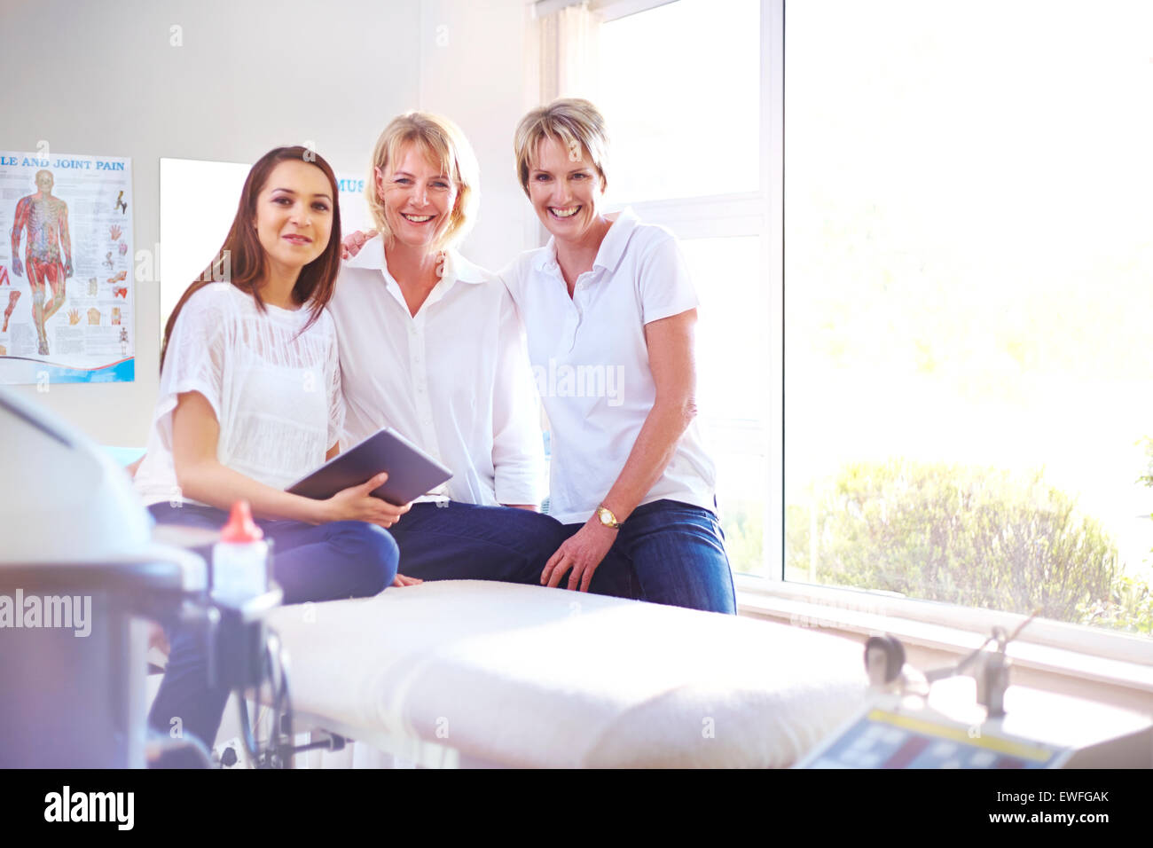 Portrait smiling physical therapists in examination room Stock Photo ...