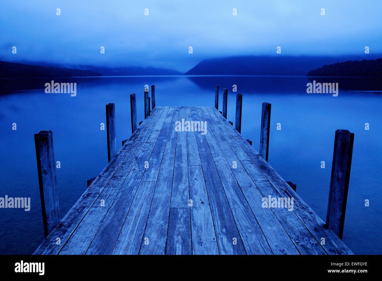Tranquil peaceful lake with blue jetty Stock Photo - Alamy