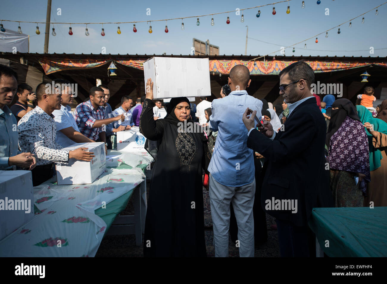 Cairo, Egypt. 24th June, 2015. An Egyptian woman takes a package of ...