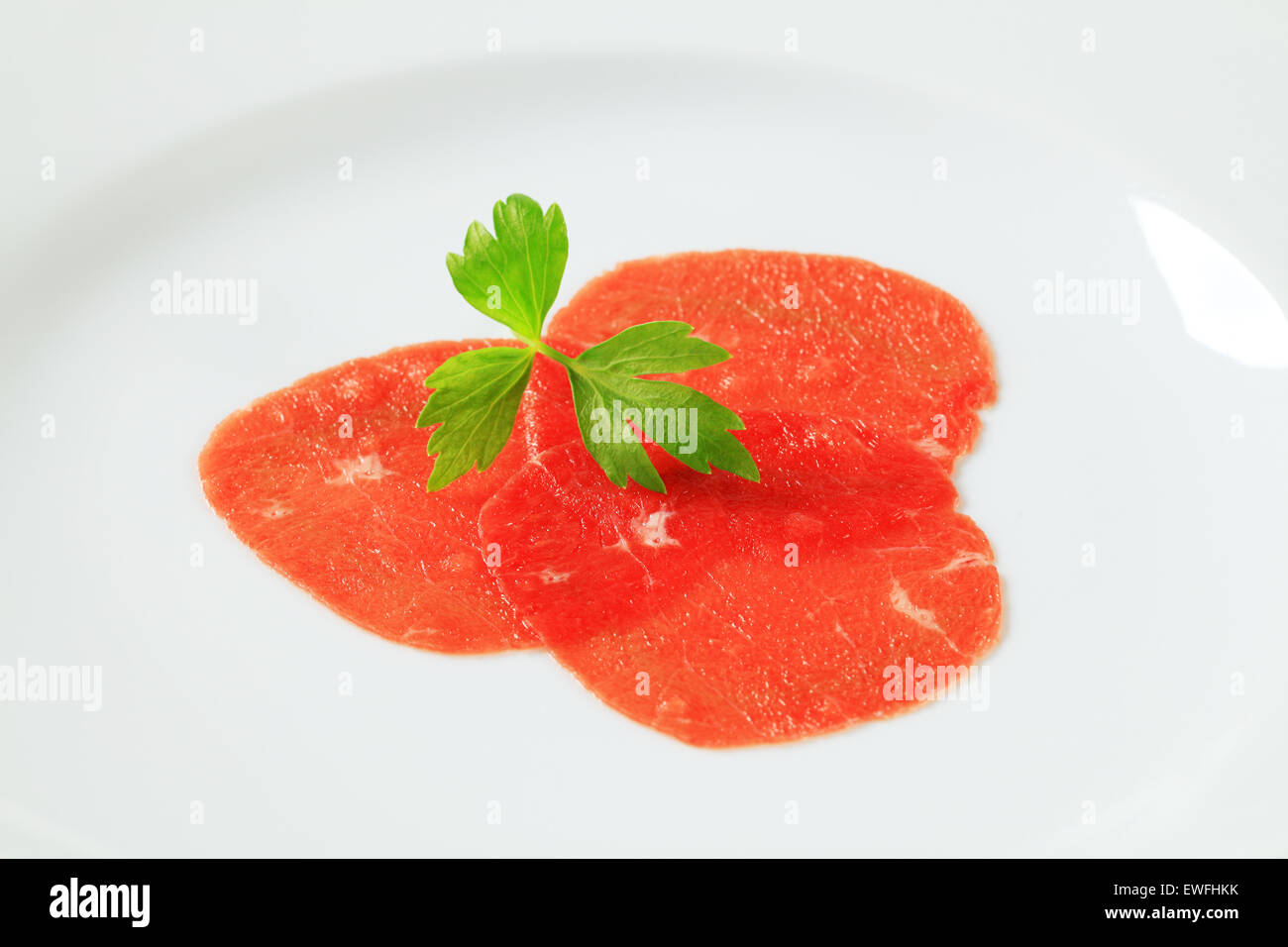 Thinly sliced raw beef tenderloin Stock Photo - Alamy