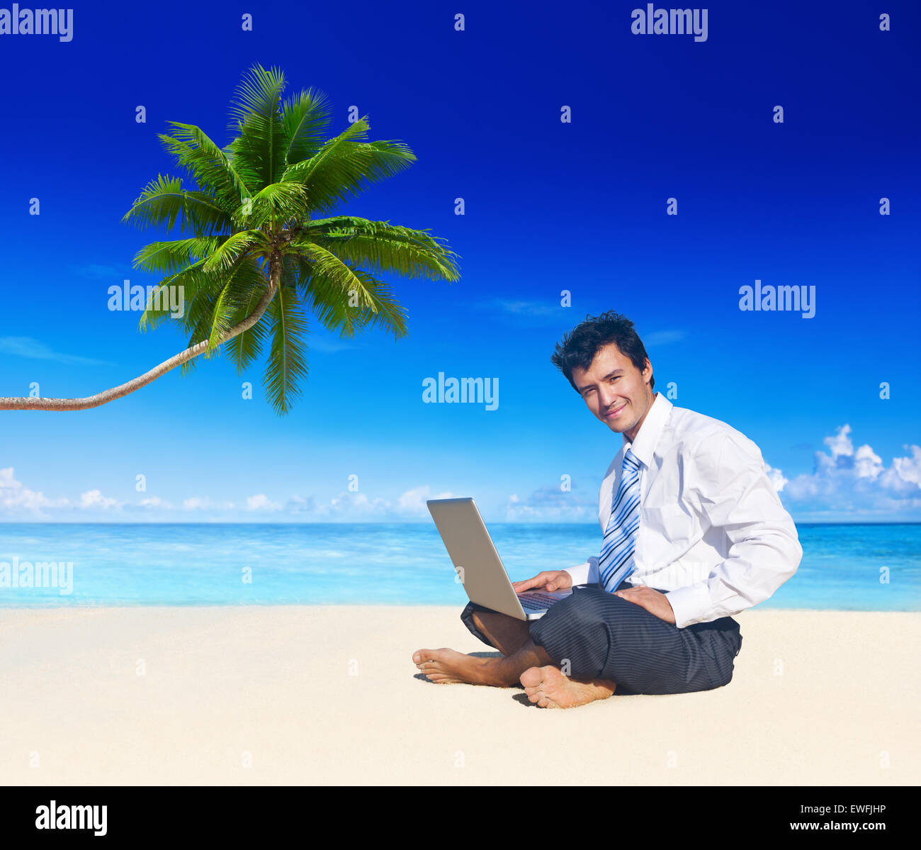 Businessman working on the beach Stock Photo - Alamy