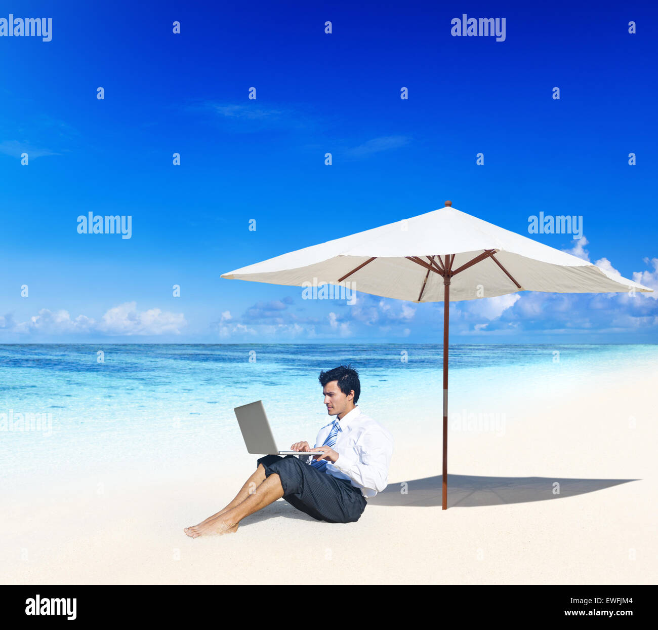 A man working on the beach Stock Photo - Alamy