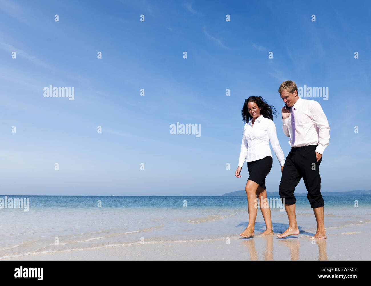 Business Colleagues walking on a beach Stock Photo - Alamy