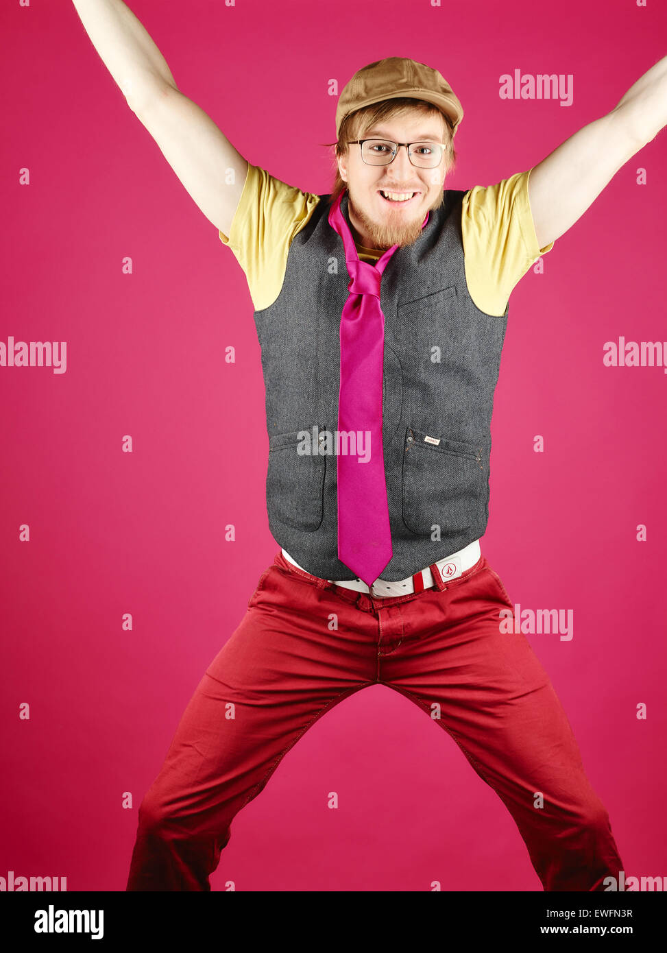 Expressive hipster wearing a vest and pink tie, pink background and ...