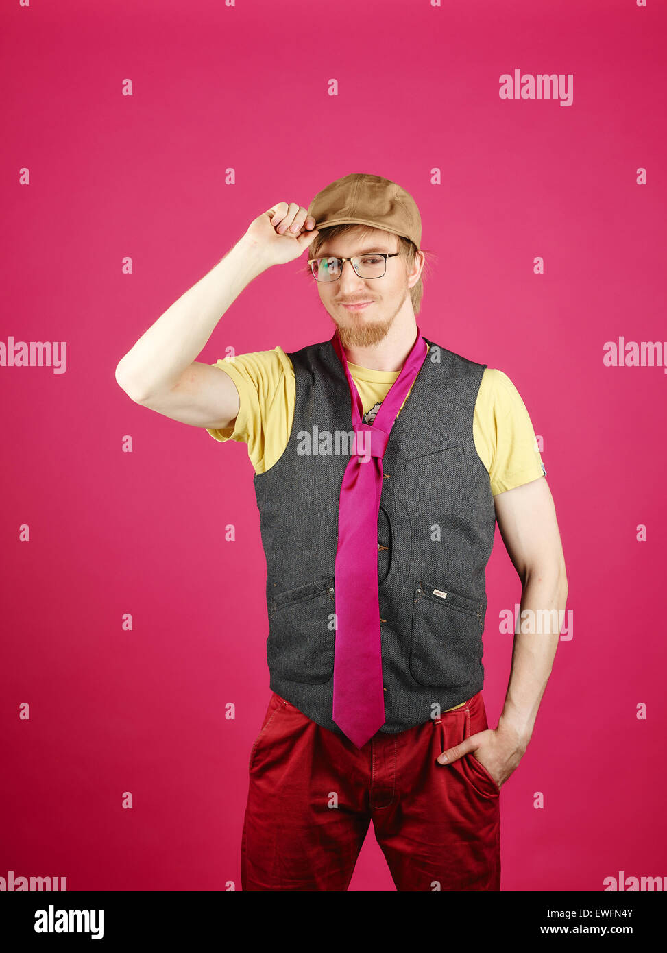 Expressive hipster wearing a vest and pink tie, pink background and ...