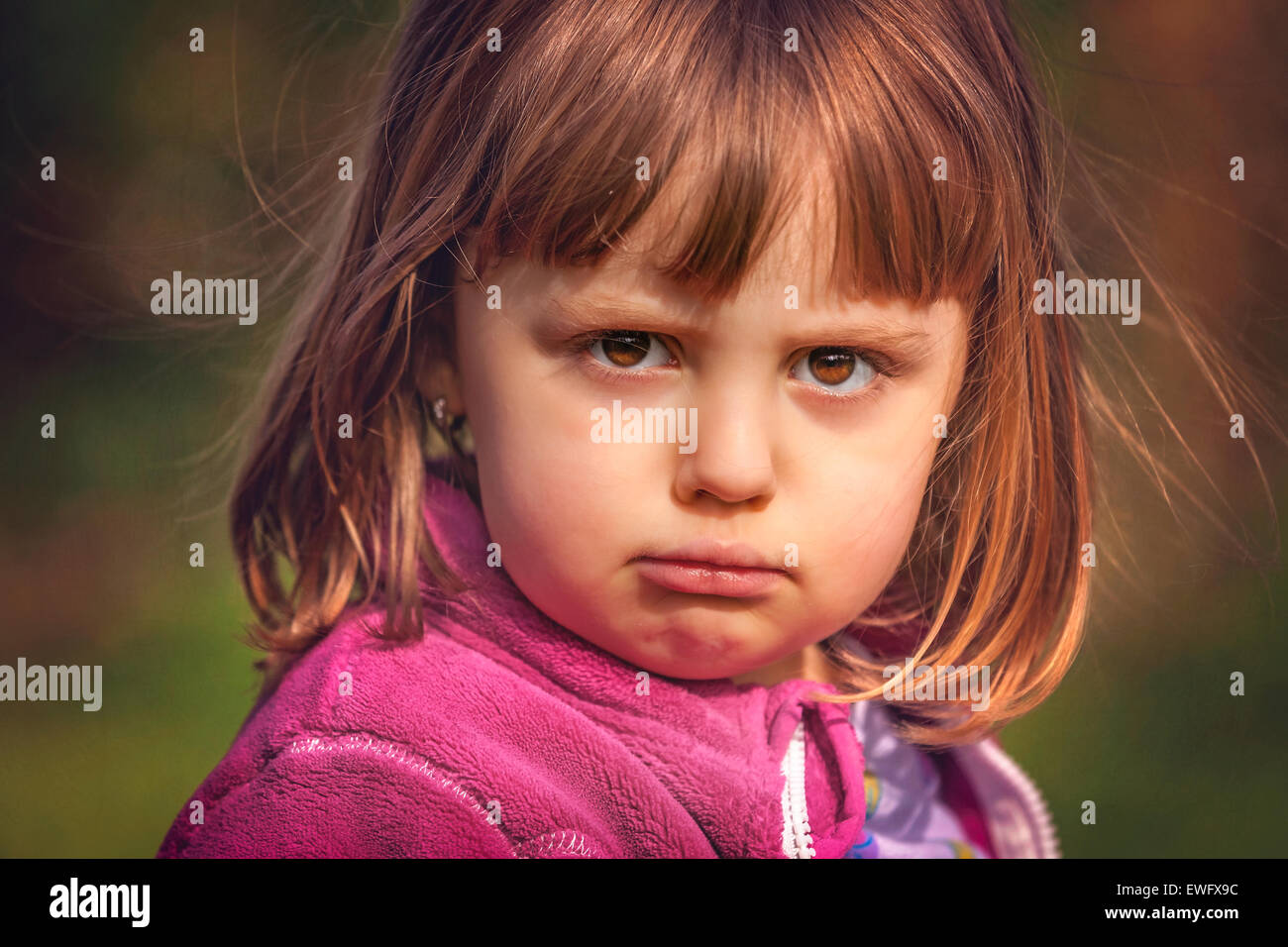 Portrait of a cute little girl being slightly angry Stock Photo - Alamy