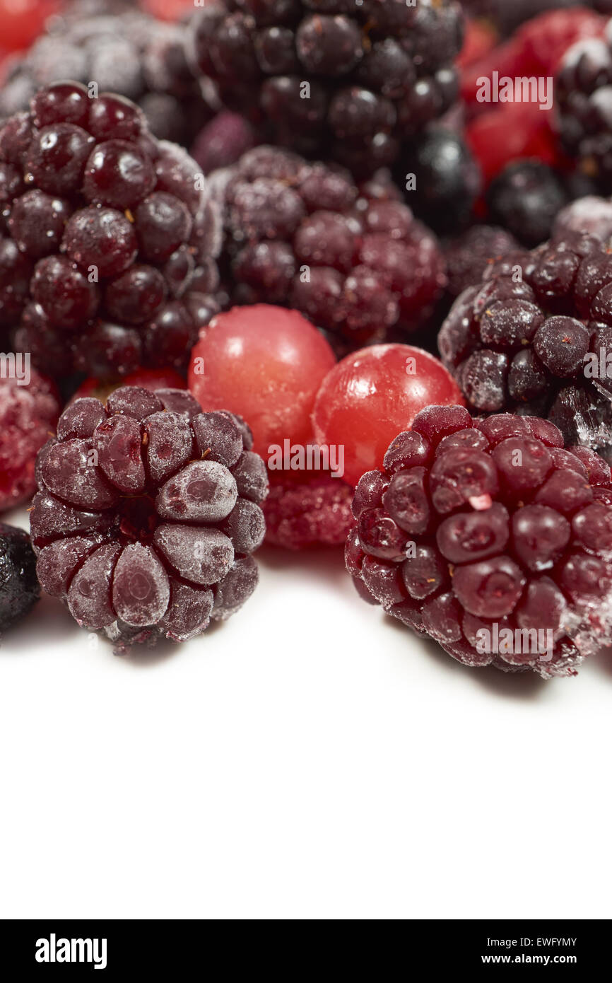 Many mixed frozen berry fruits on white background with copy space ...