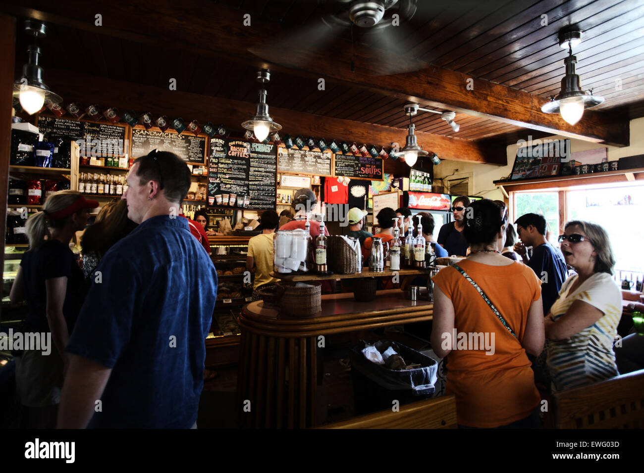 A group of people are seen standing in line at a busy restaurant ...