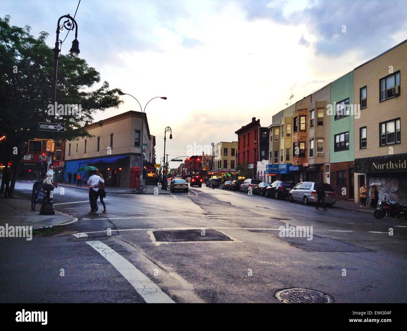 A busy street intersection lined with various shops, capturing the ...