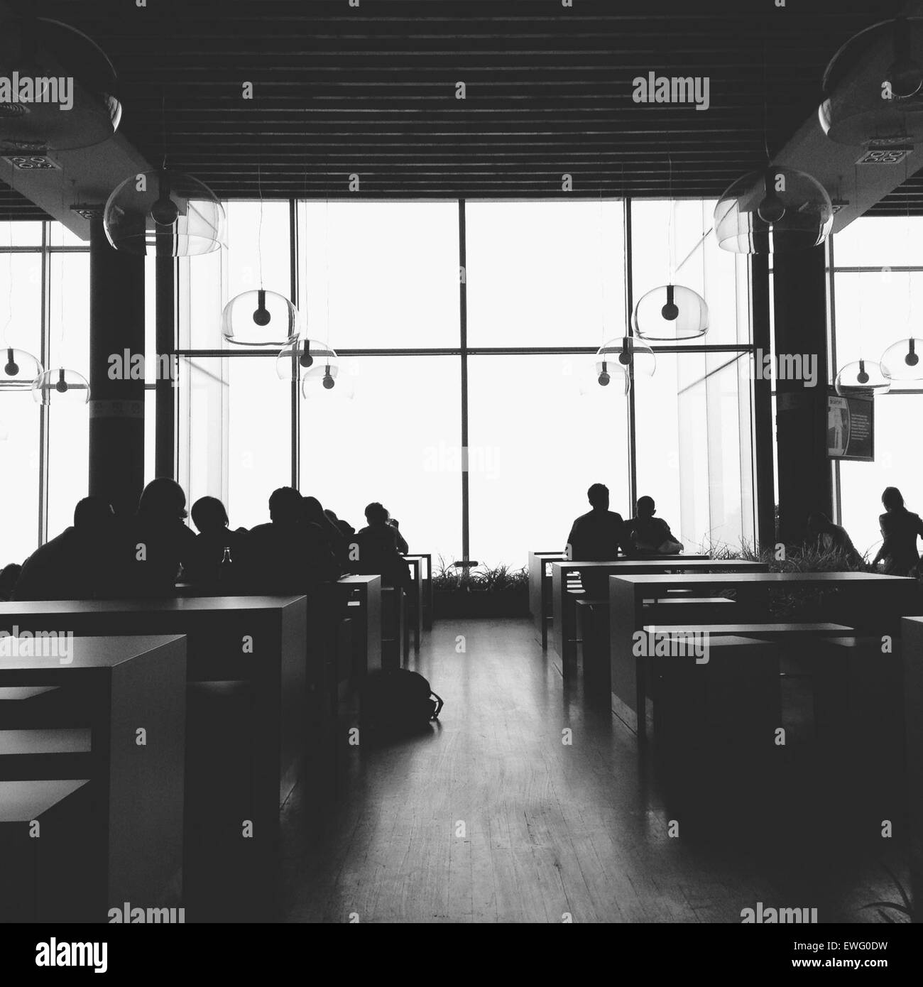 A monochrome image of an indoor restaurant, featuring sleek, minimalist ...
