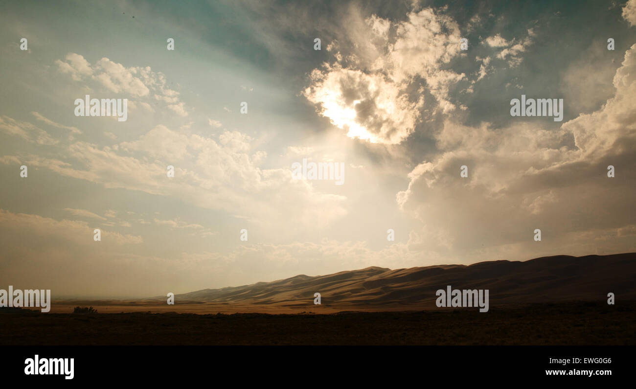 Landscape of Sun Behind Clouds Over Valley Stock Photo - Alamy