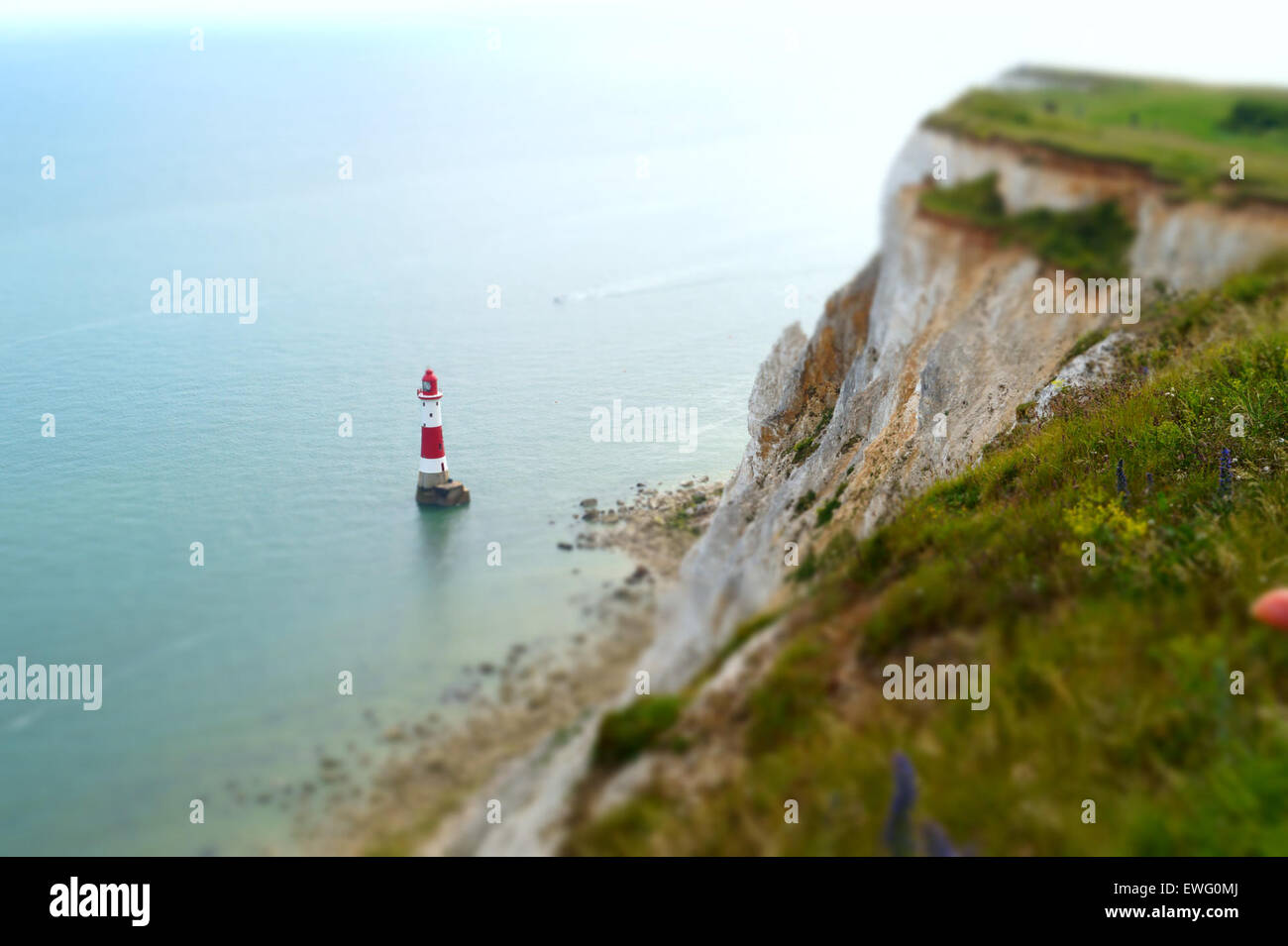 An ocean lighthouse stands tall on a cliffside, overlooking the vast ...