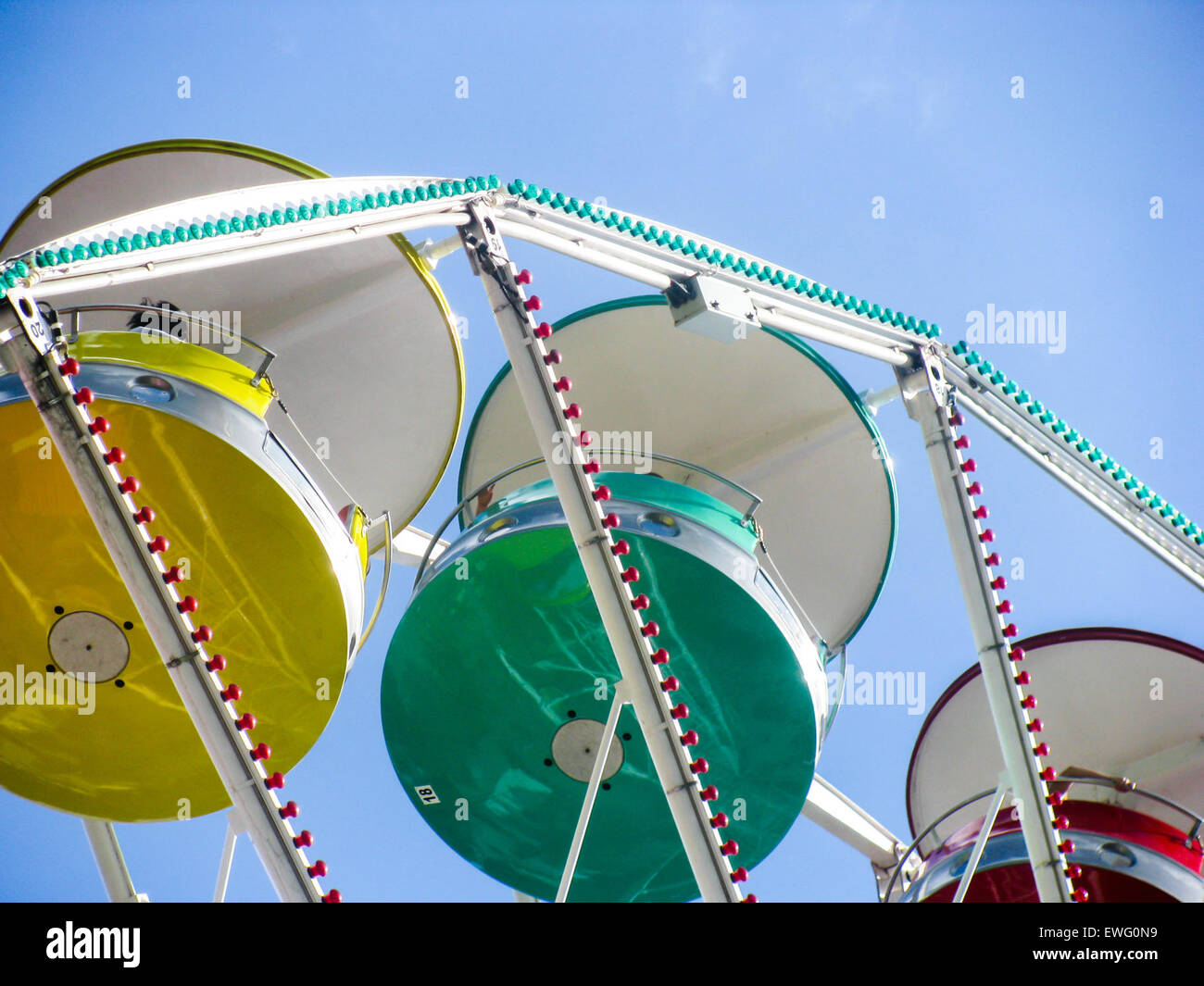 This image captures a colorful Ferris wheel, a classic carnival ride ...