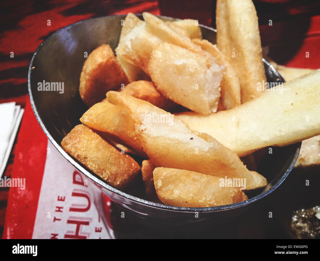 This image shows a bowl filled with various types of fried food ...