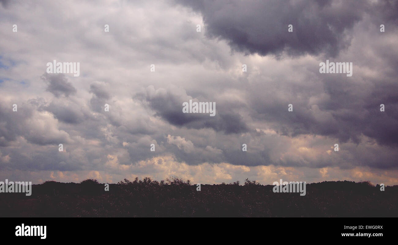 A dramatic scene of stormy clouds filling the sky, forming a thick mass ...