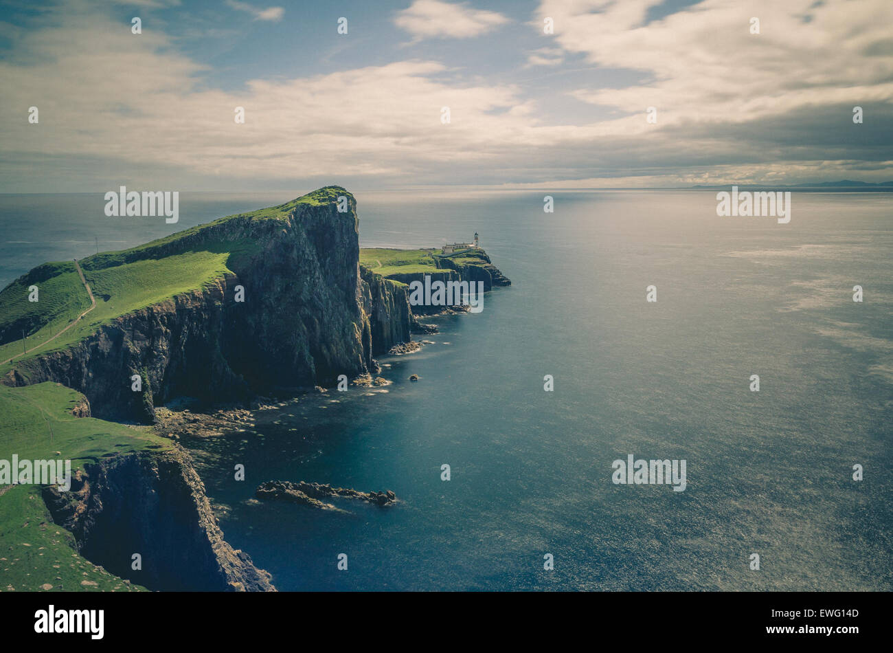 A scenic landscape showcasing towering ocean cliffs with a lighthouse ...