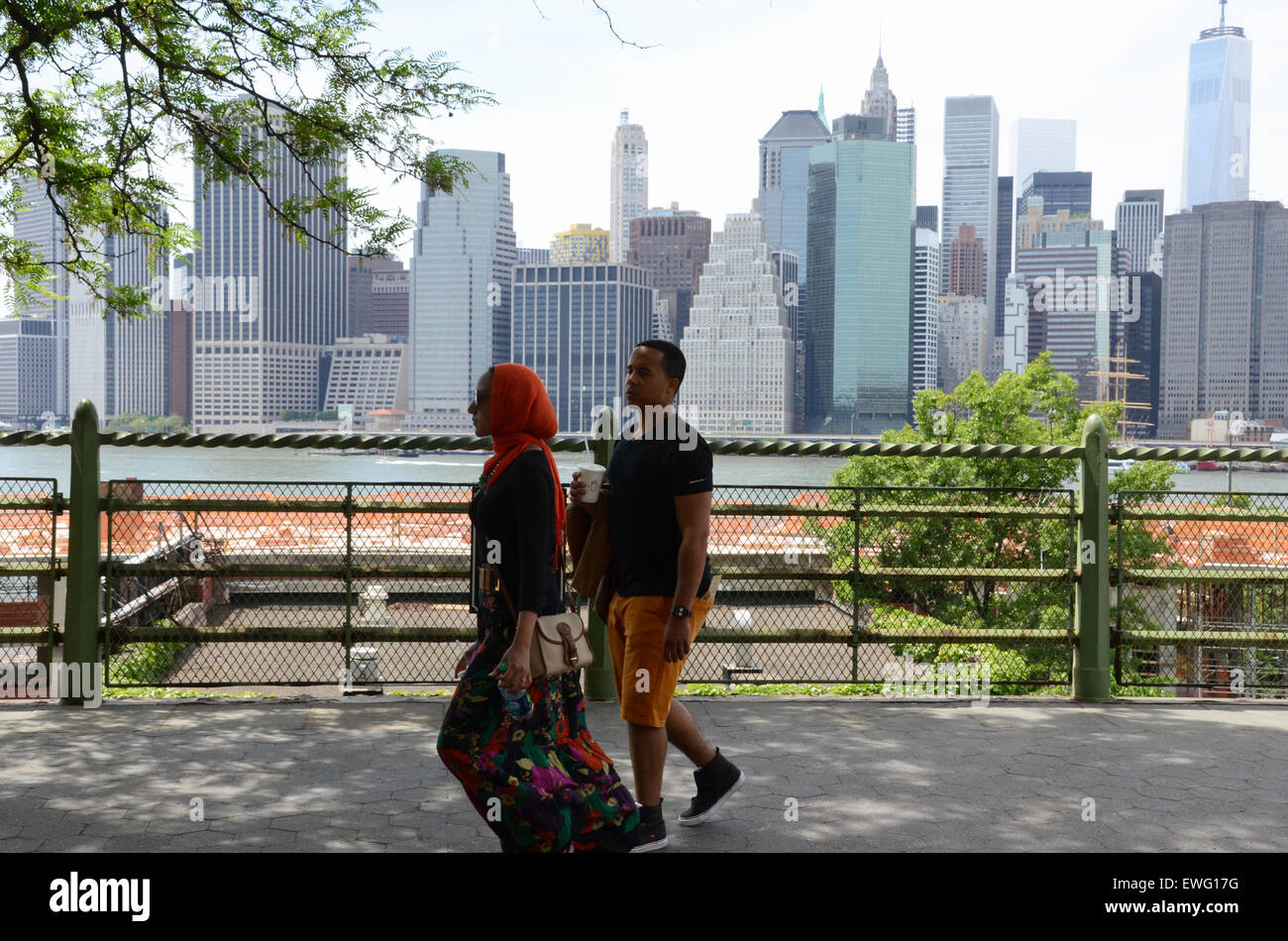 Muslim couple strolling along Brooklyn Heights with a view of Manhattan ...