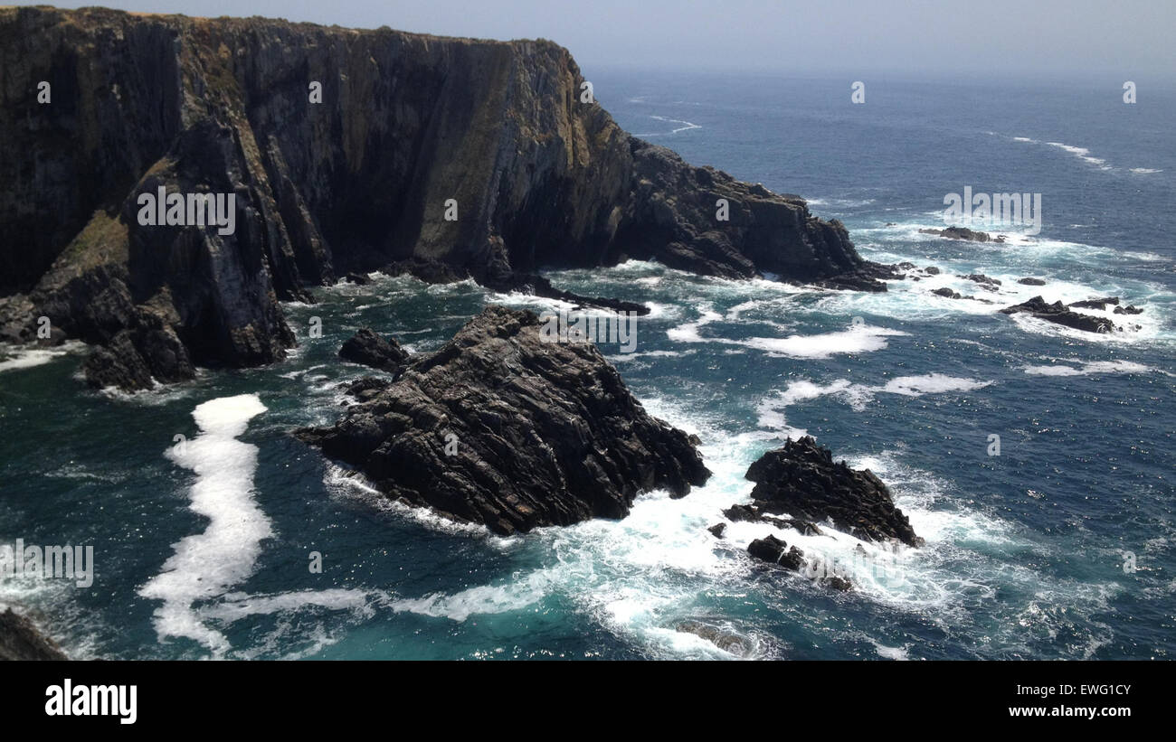 Ocean waves crashing against rocky outcrops, highlighting the power of ...