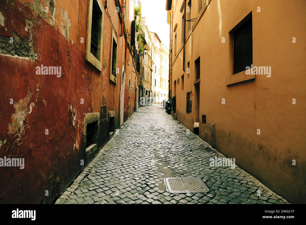 An alley between residential buildings features a pattern of brick ...