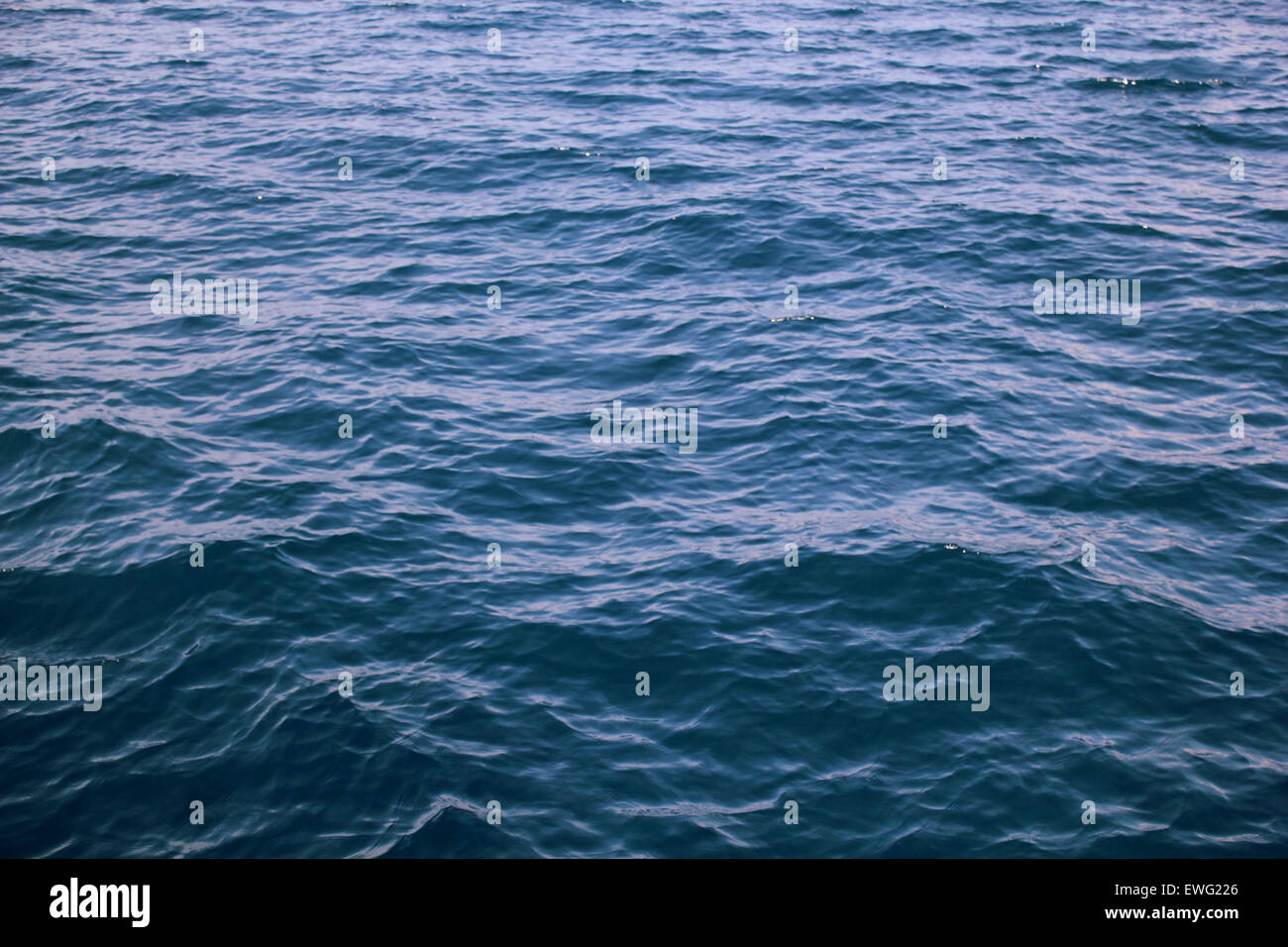 This image shows the choppy waters of the blue ocean with dark blue ...